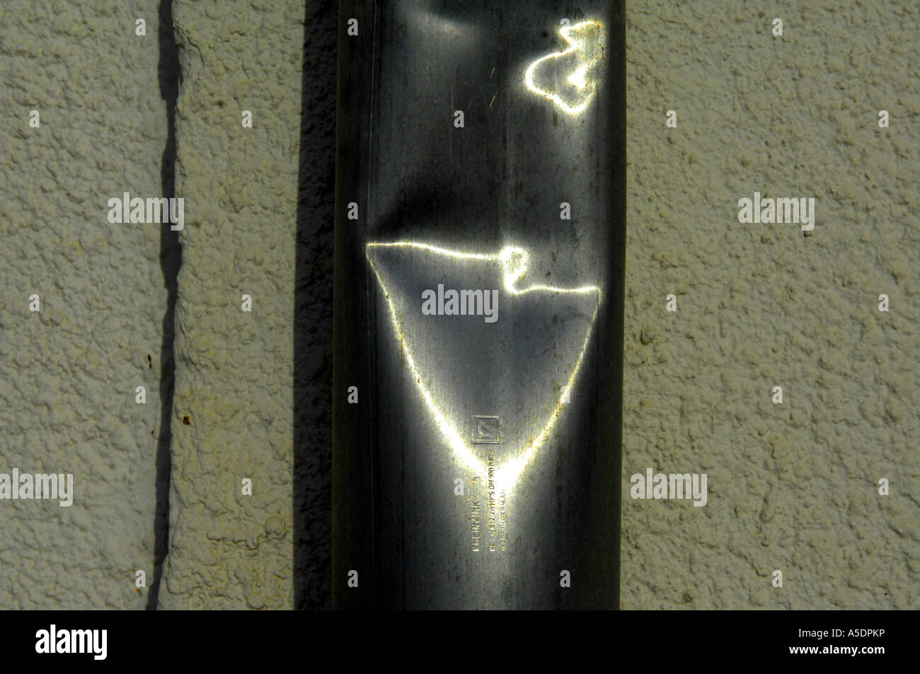 aluminium drainpipe dent dented damaged silver street urban wall detail ...