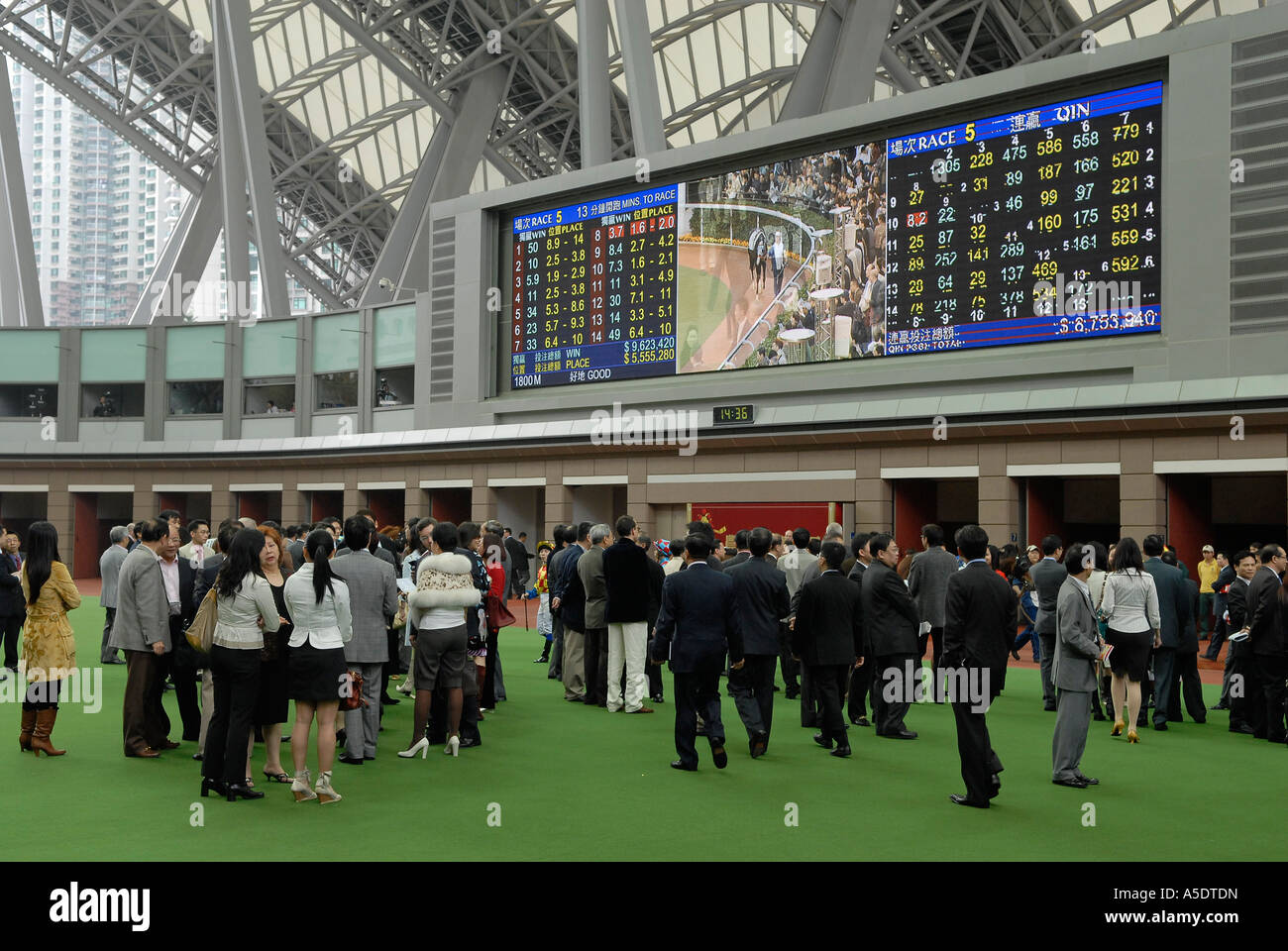 A digital screen displays horse racing results and a streaming video of ...