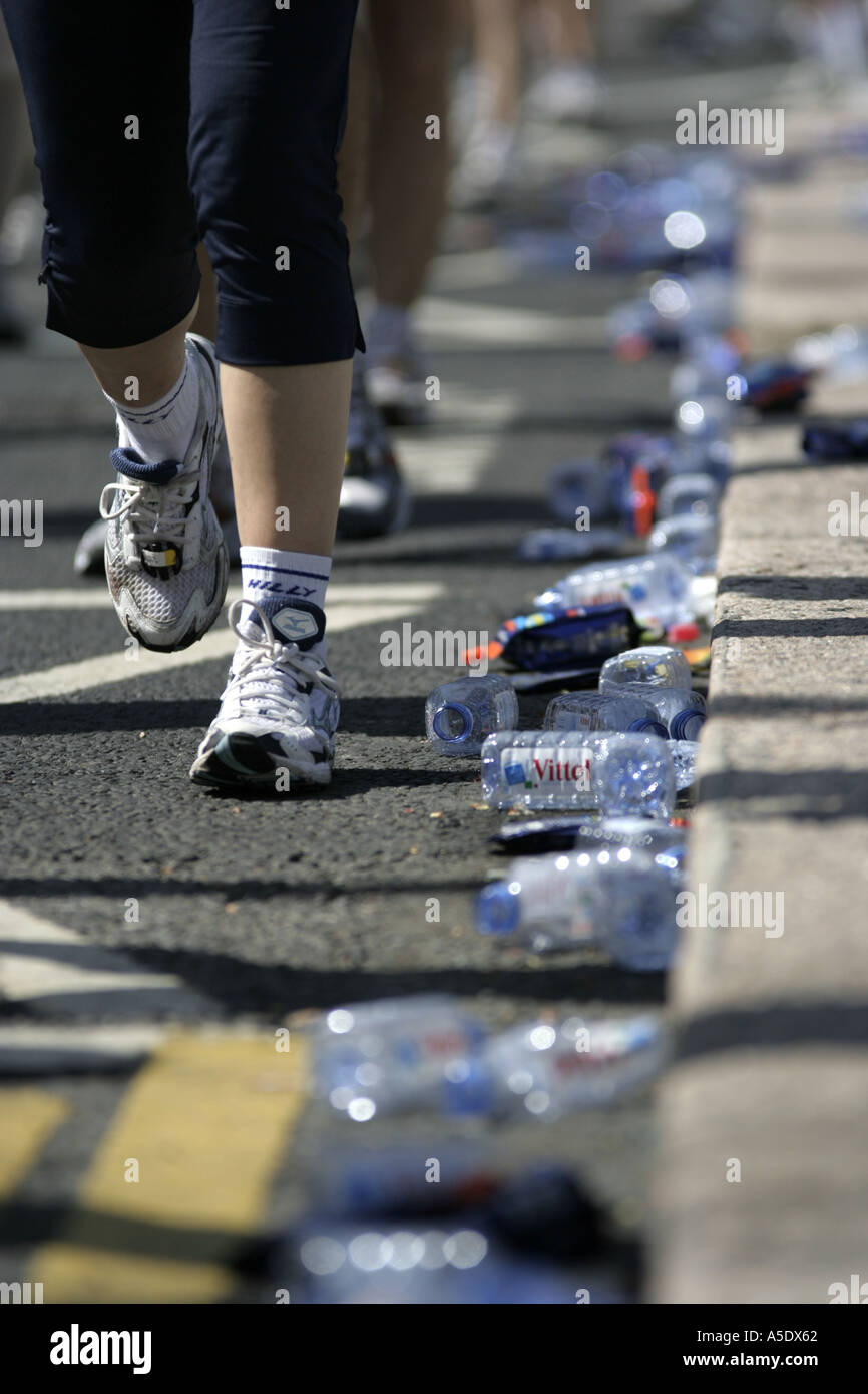 running past empty water bottles at the London Marathon Stock Photo - Alamy