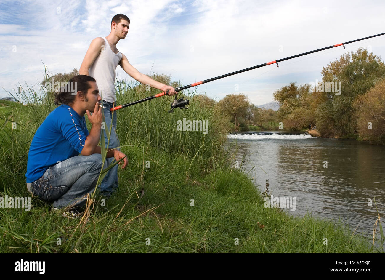 Two fishermen On the Jordan River Stock Photo - Alamy