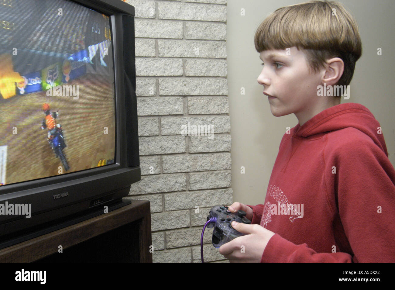 10 yr old playing video game 1 Stock Photo - Alamy