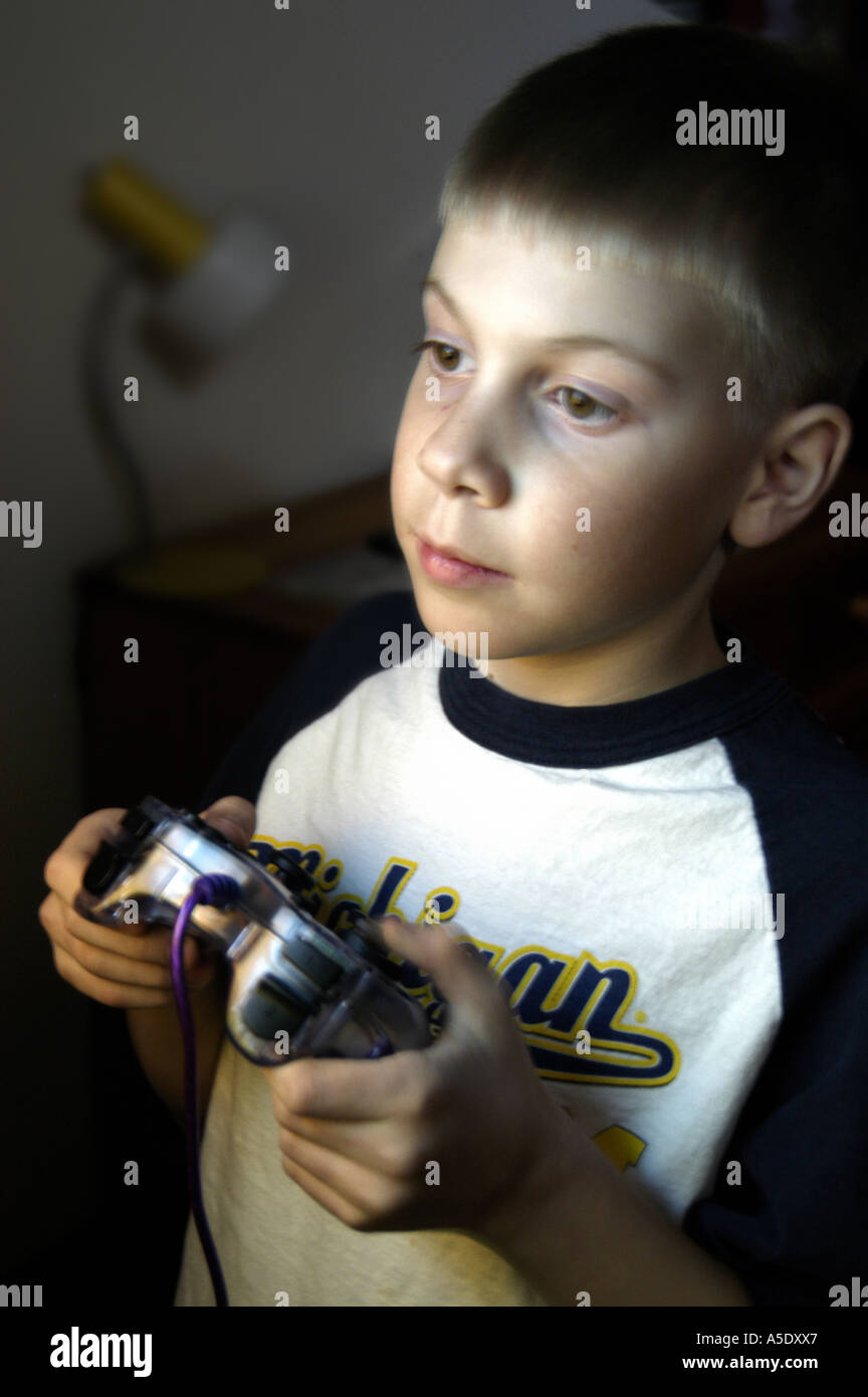 10 yr old playing video game 4 Stock Photo - Alamy
