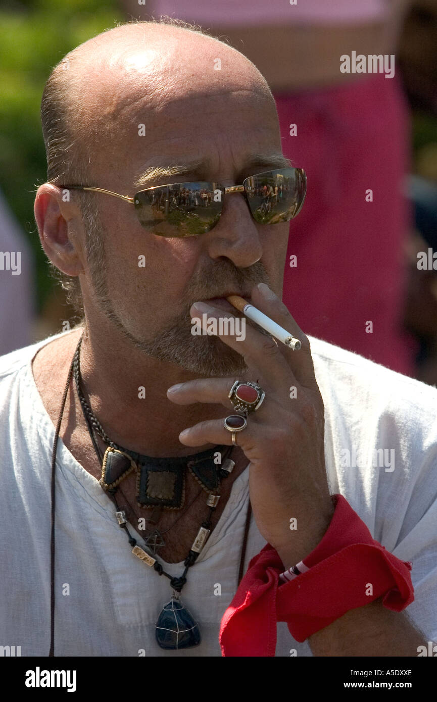 A bold man smoking a cigarette Stock Photo - Alamy