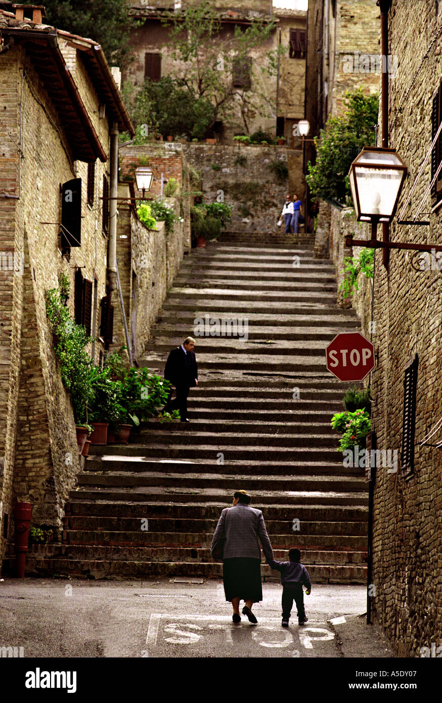 A wide street of stairs in a Italian hill top town San Gimignano Italy ...