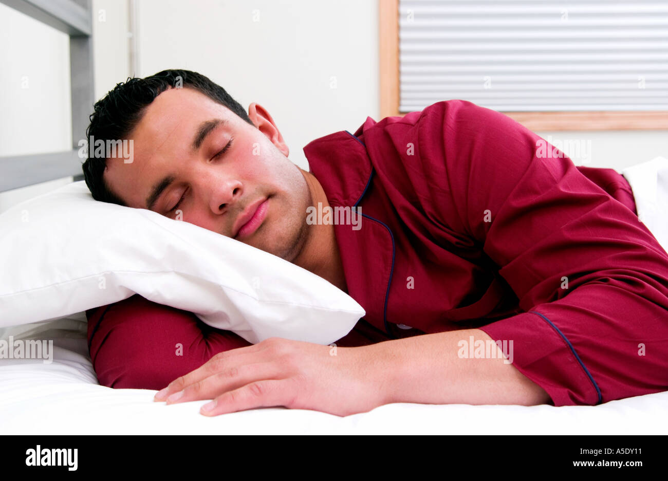 Hispanic man sleeping in bed Stock Photo - Alamy