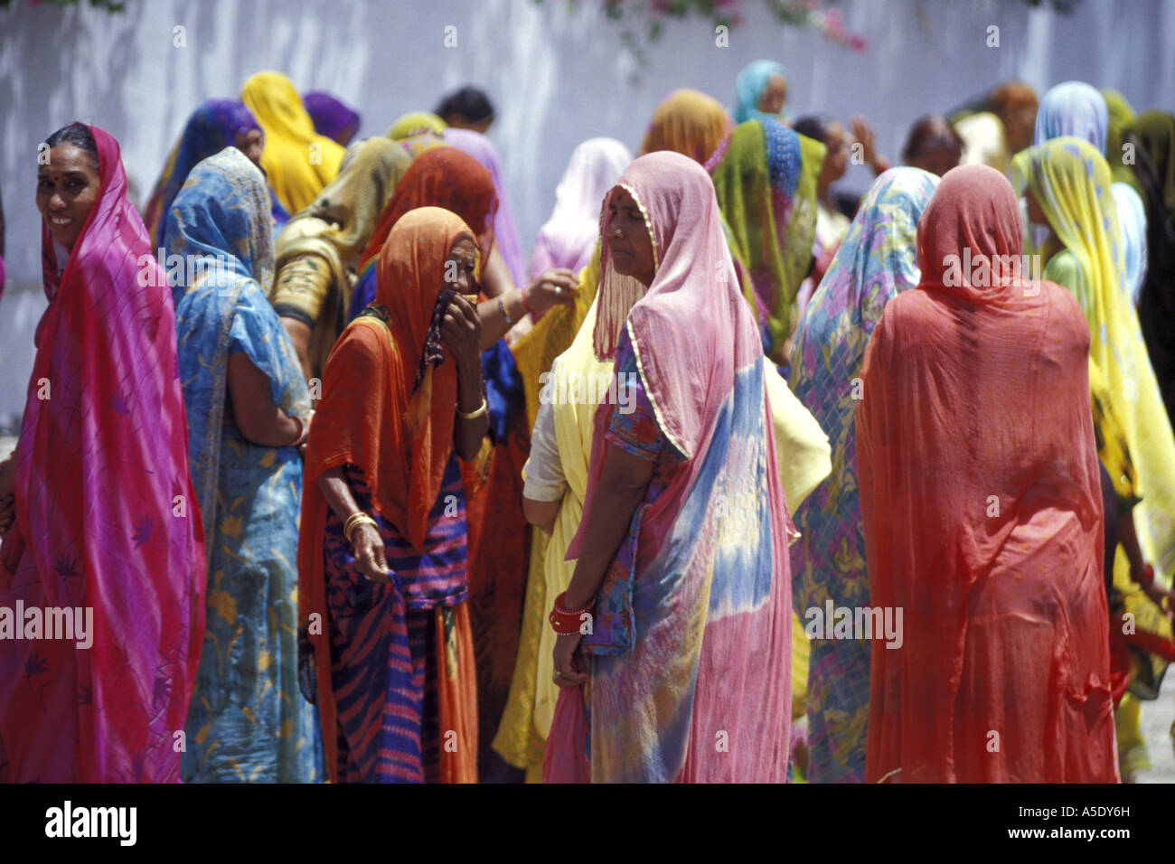 Pied Rajasthan women at a ceremonial ablution after a funeral, India ...