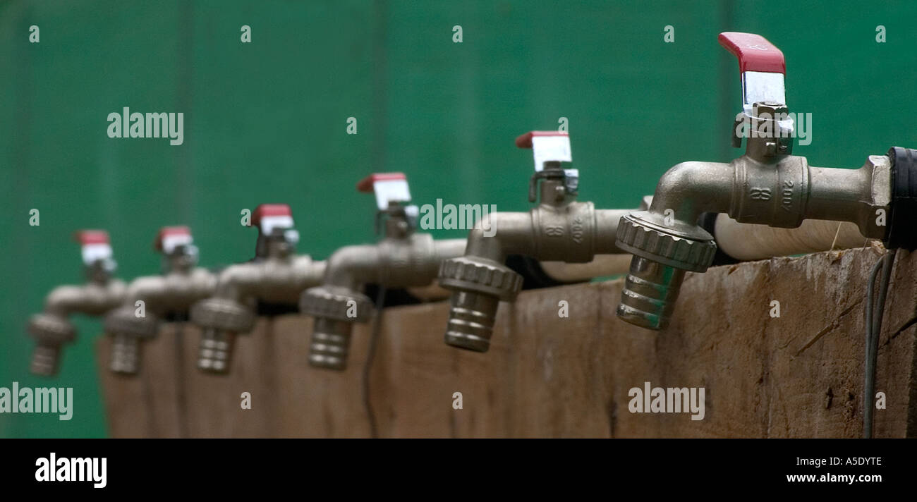 A row of Water faucets fading out of focus Stock Photo - Alamy
