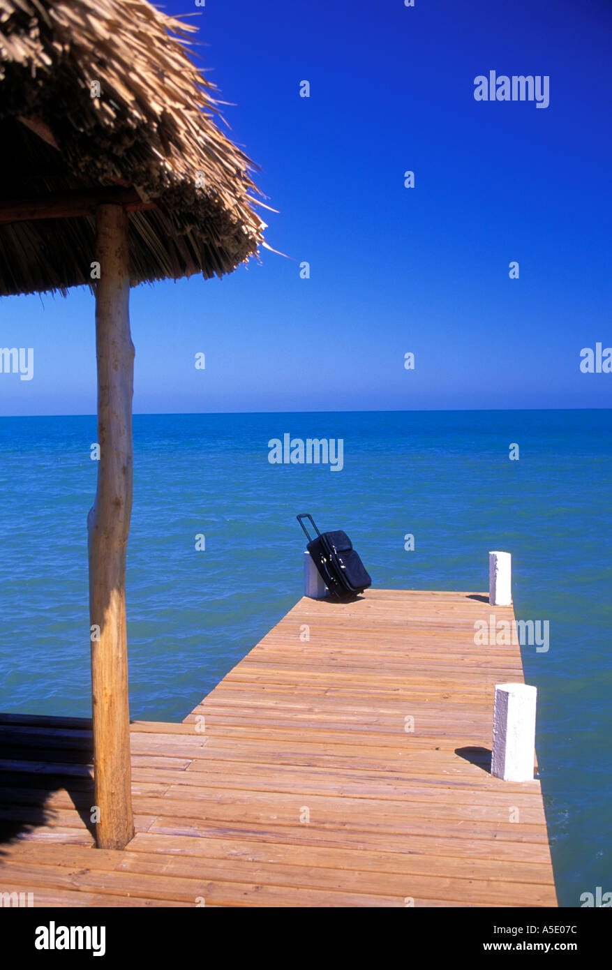 Suitcase on end of boat dock in Belize Central America Caribbean Stock ...