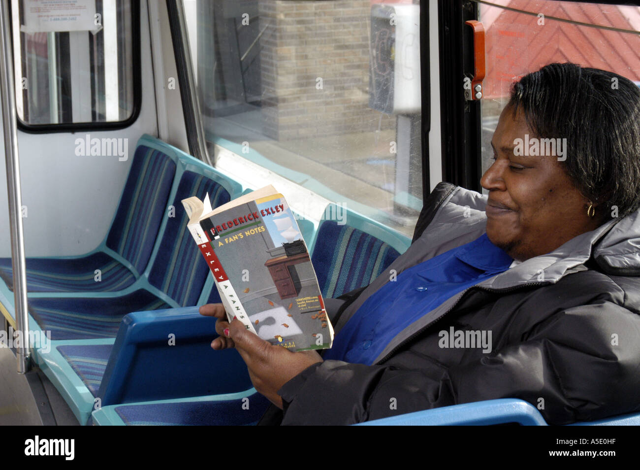 Reading On Bus 3 Stock Photo - Alamy