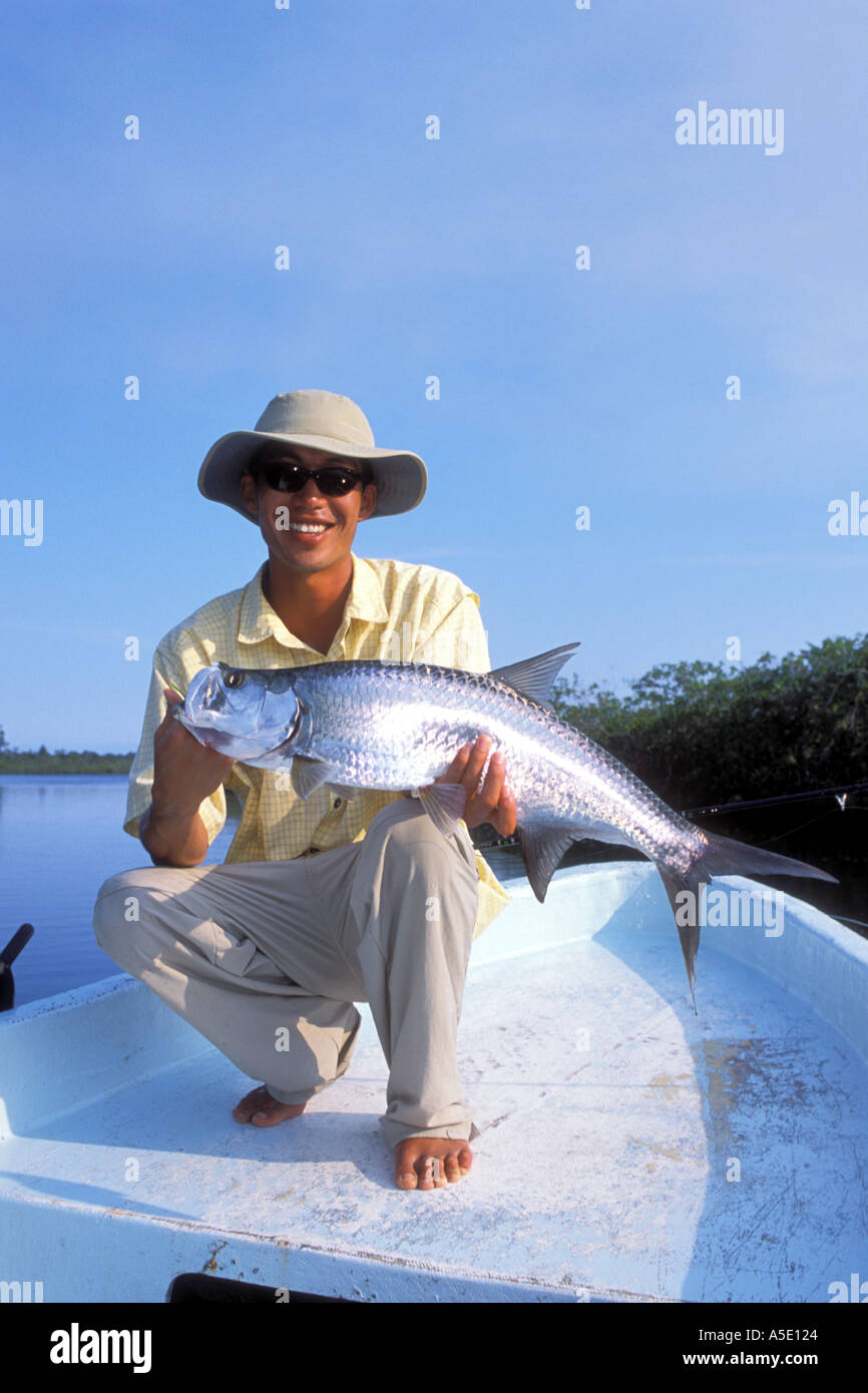 Man holding tarpon fish caught while fly fishing in Belize Central ...