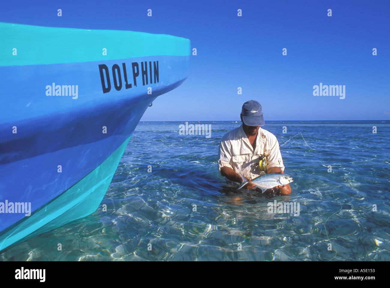 Man holding fish caught while fly fishing in Belize Central America ...