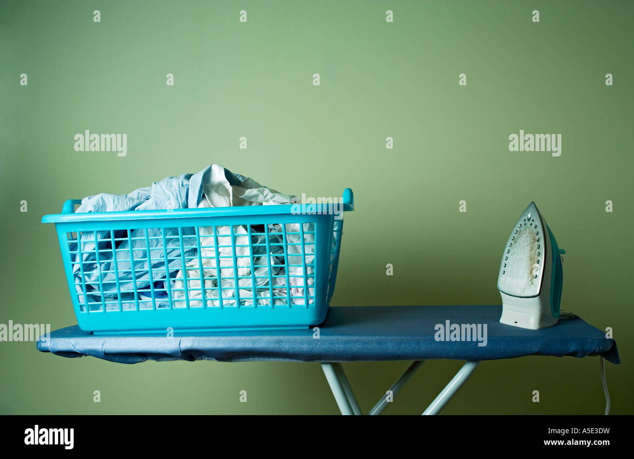 Washing in basked on ironing board Stock Photo - Alamy