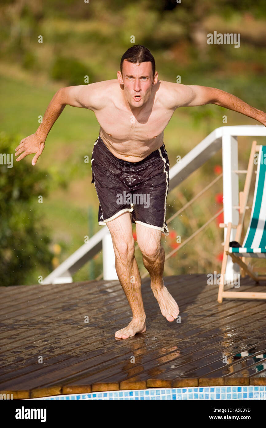Man Jumping into Swimming Pool Stock Photo - Alamy