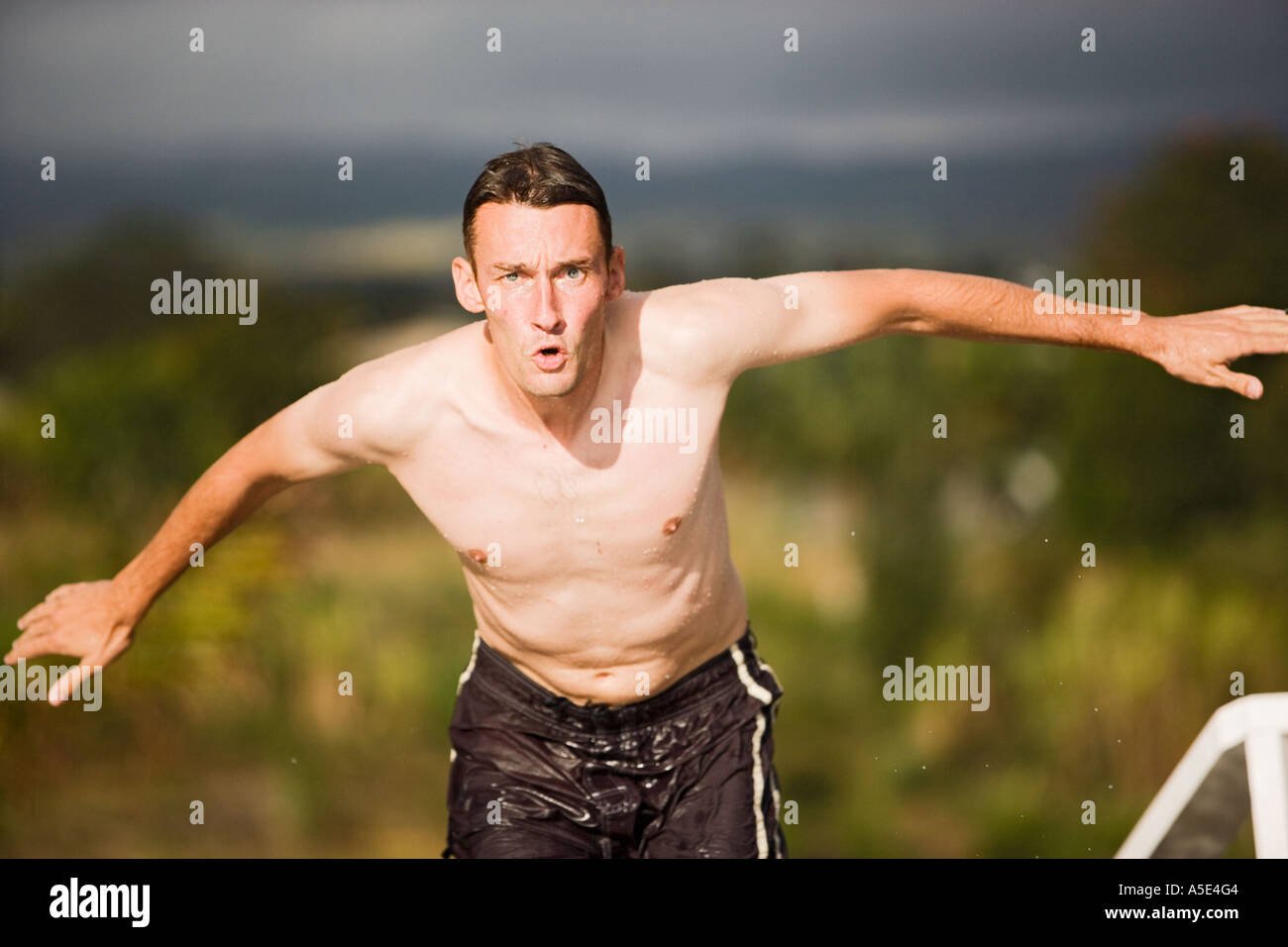 Man Jumping into Swimming Pool Stock Photo - Alamy