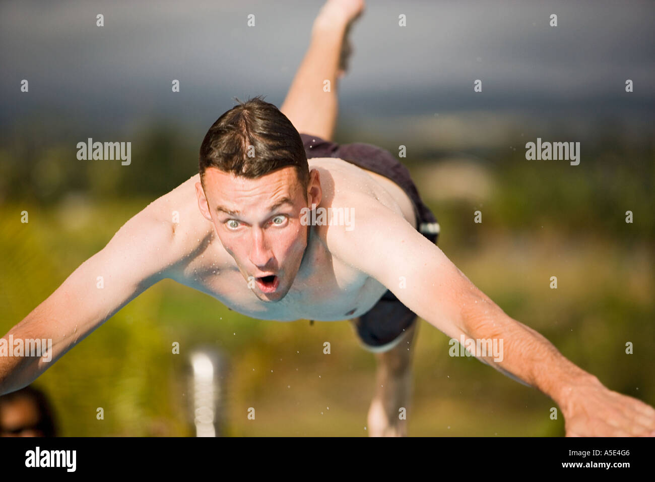 Man Jumping into Swimming Pool Stock Photo - Alamy