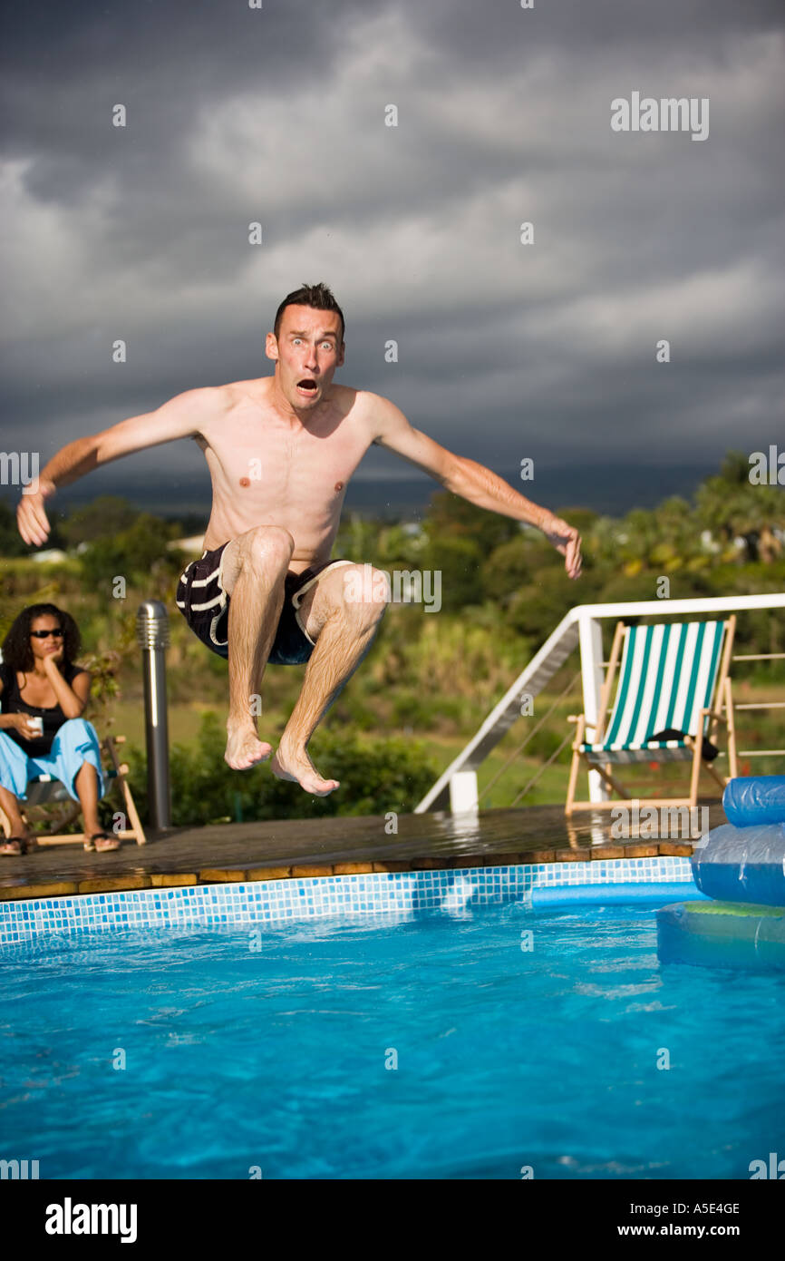 Man Jumping into Swimming Pool Stock Photo - Alamy