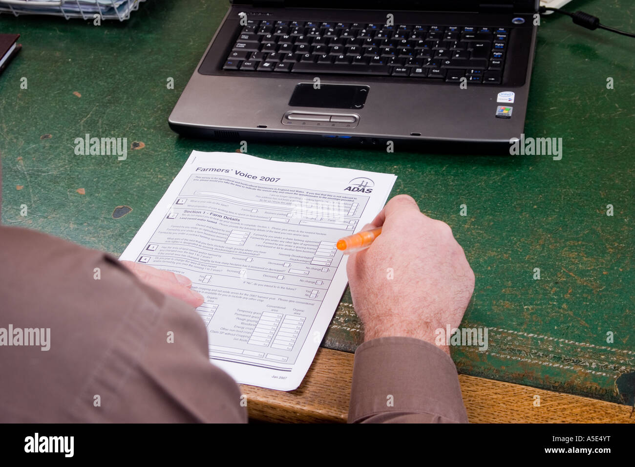 Farmer working in the farm office on paperwork Stock Photo - Alamy