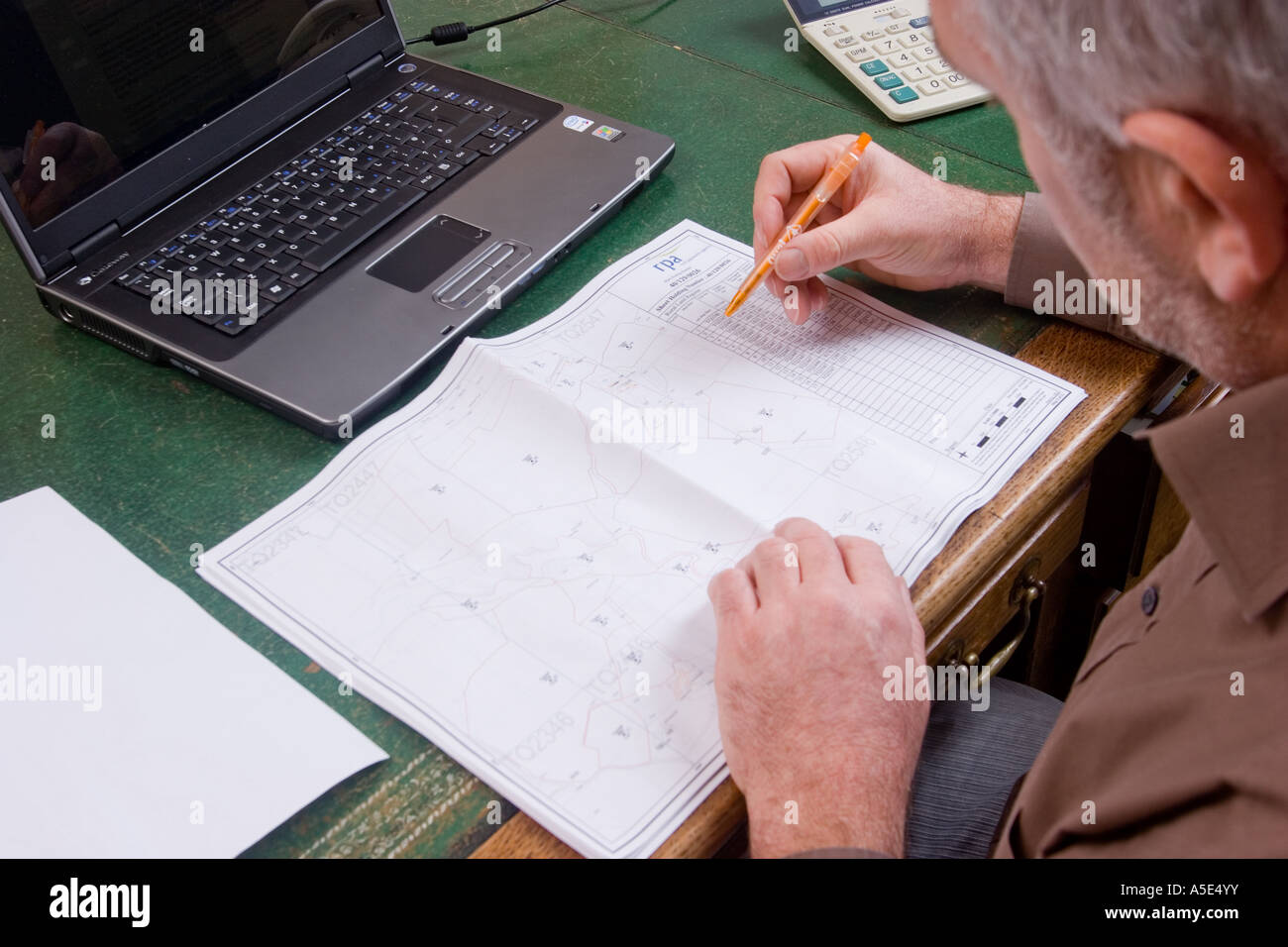 Farmer working in the farm office on paperwork Stock Photo - Alamy