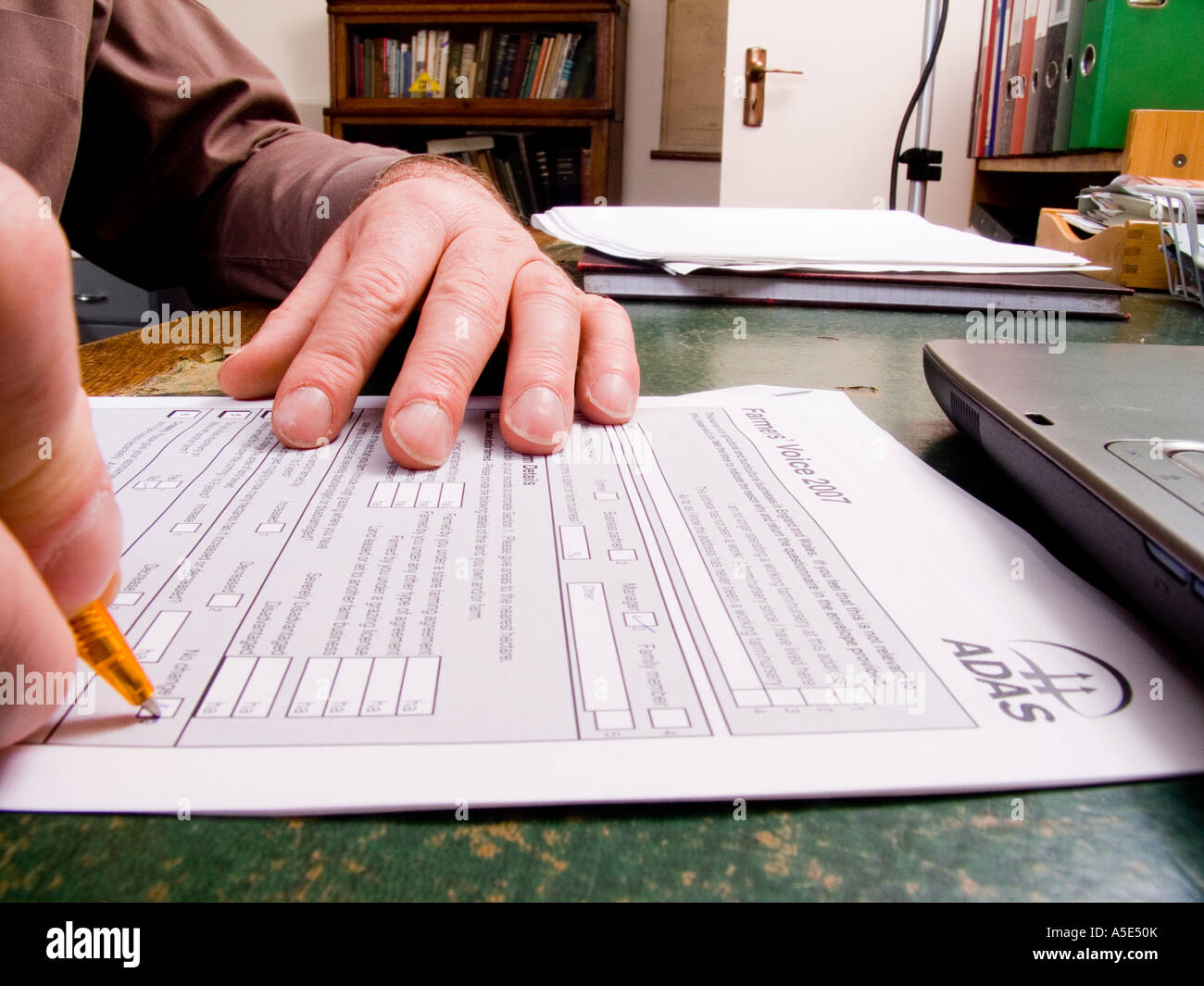 Farmer working in the farm office on paperwork Stock Photo - Alamy