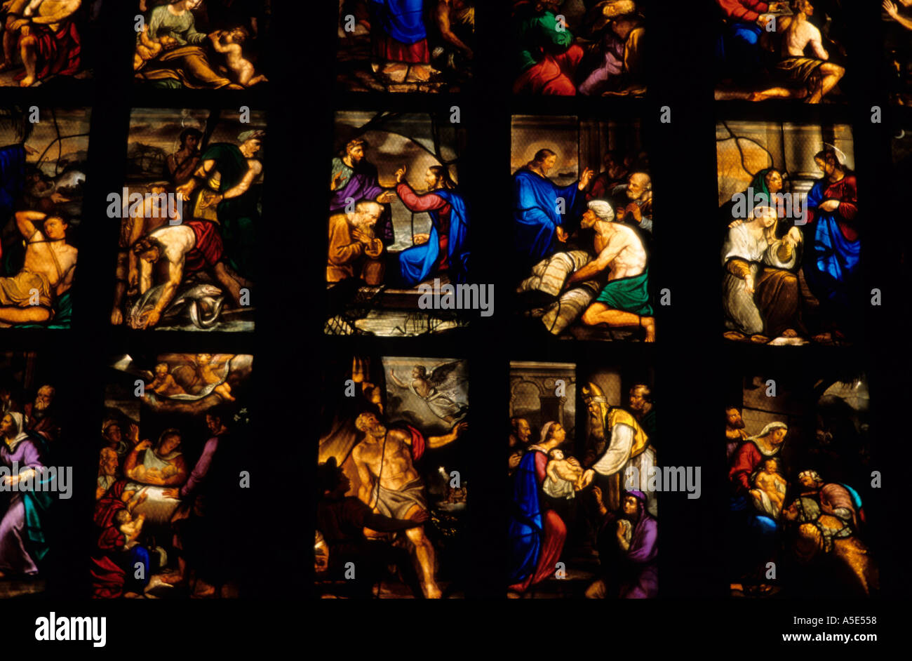 Brightly colored stained glass window depicting a religious story ...