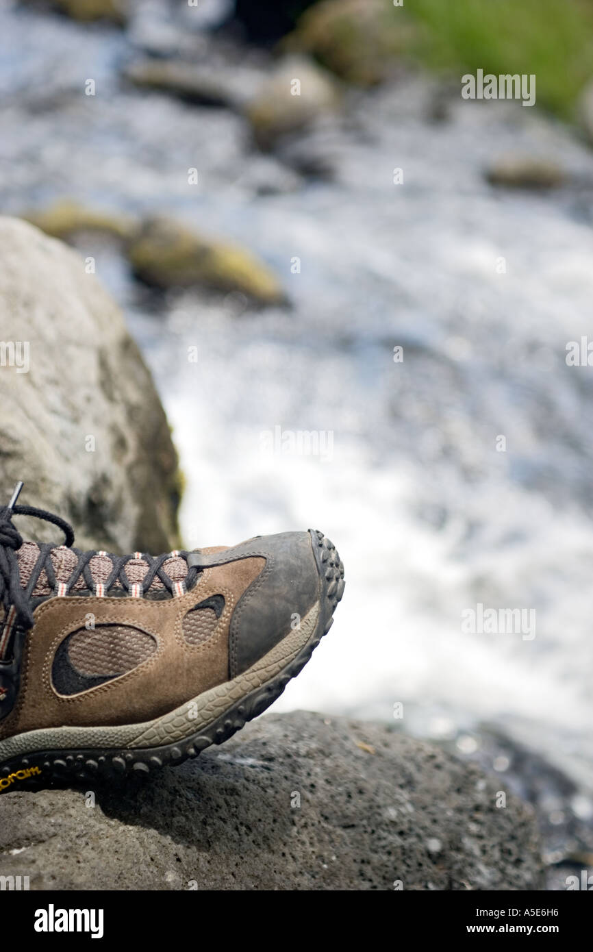 Foot on Rock near fast moving river Stock Photo - Alamy