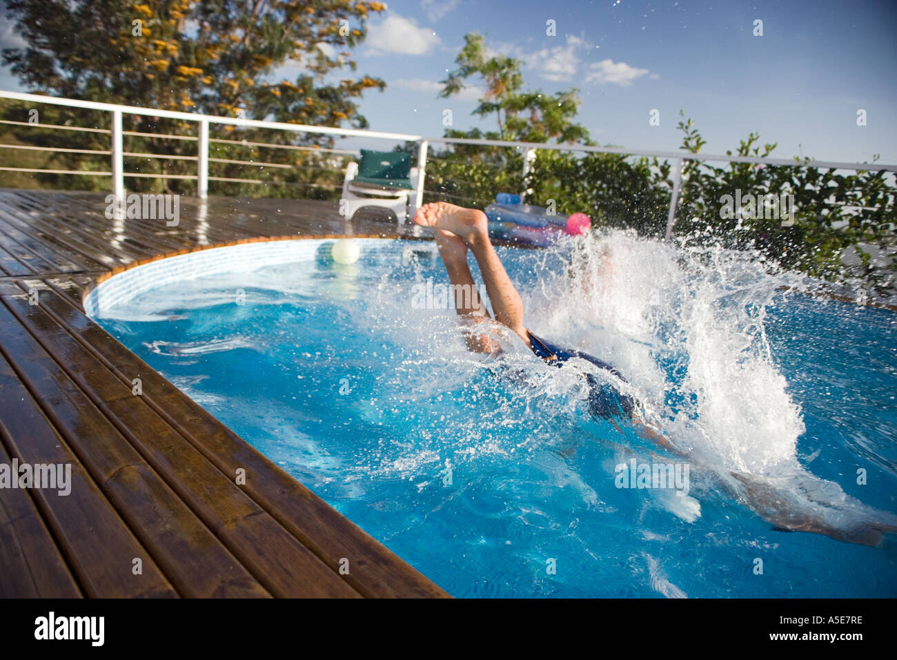 Two Men Running and Jumping into Swimming Pool Stock Photo - Alamy
