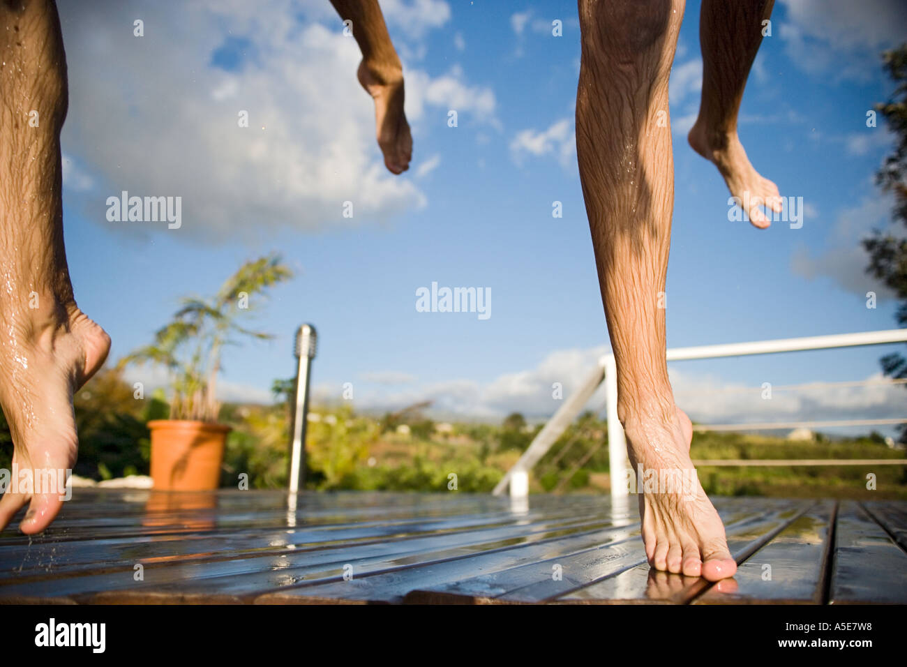 Two Men Running and Jumping into Swimming Pool Stock Photo - Alamy