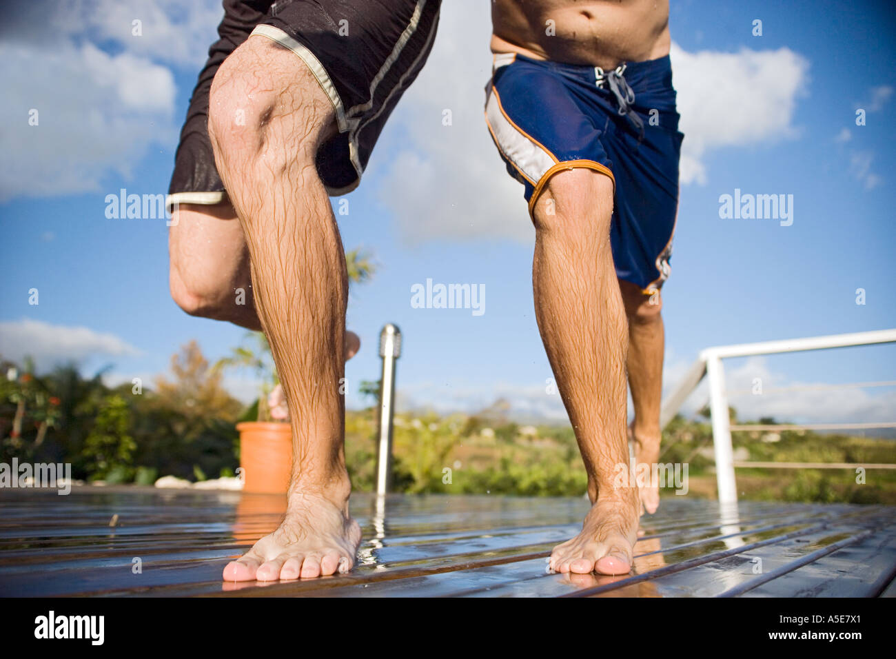 Two men Jumping into swimming pool Stock Photo - Alamy