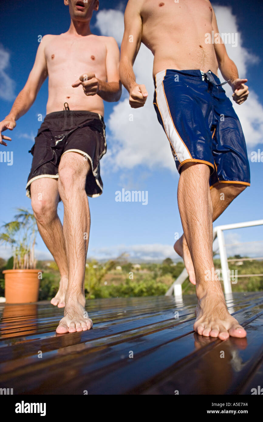 Two men Jumping into swimming pool Stock Photo - Alamy