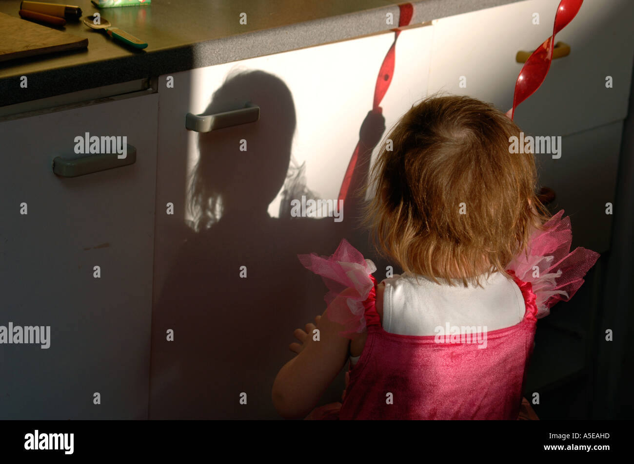Little Girl Playing With Her Shadow Stock Photo - Alamy