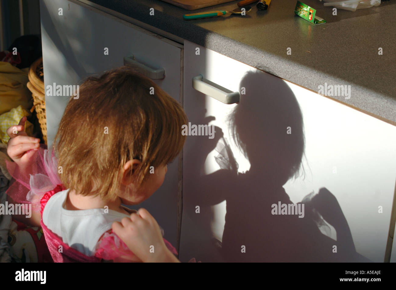 Little Girl Playing With Her Shadow Stock Photo - Alamy