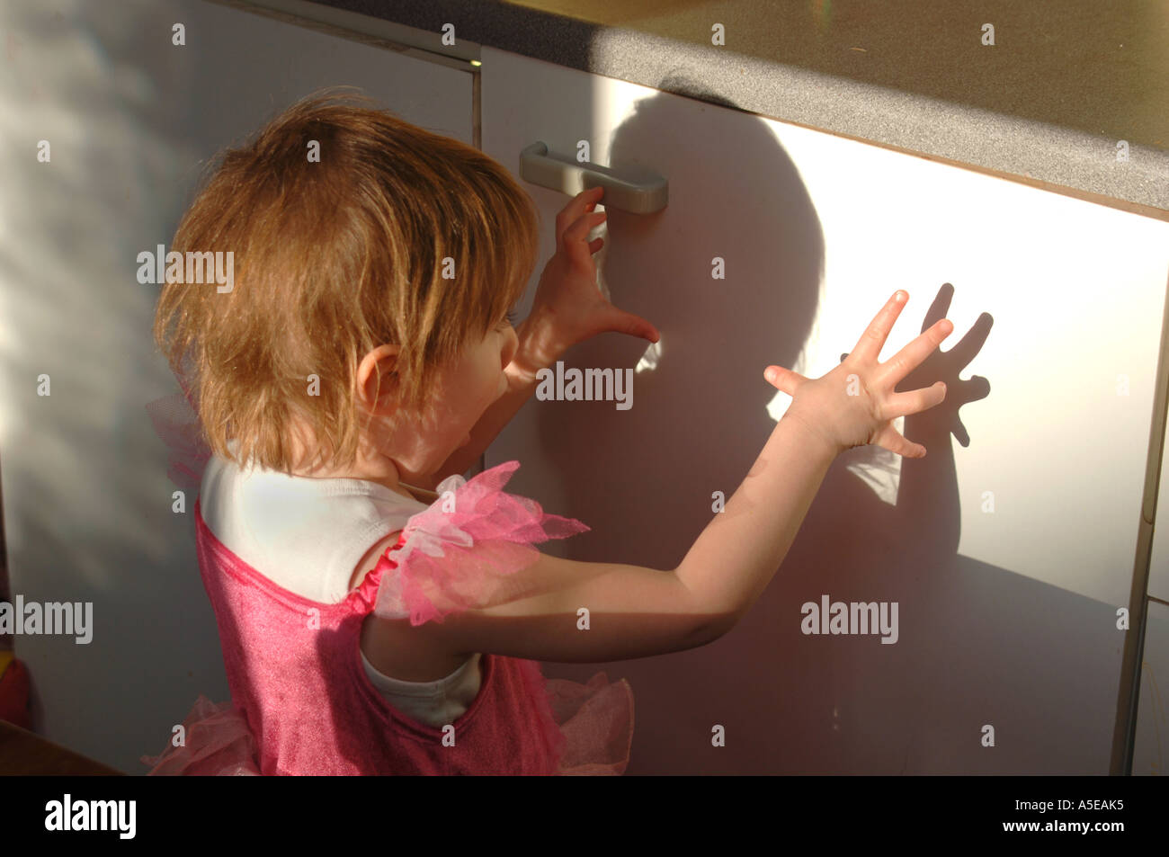 Little Girl Playing With Her Shadow Stock Photo - Alamy