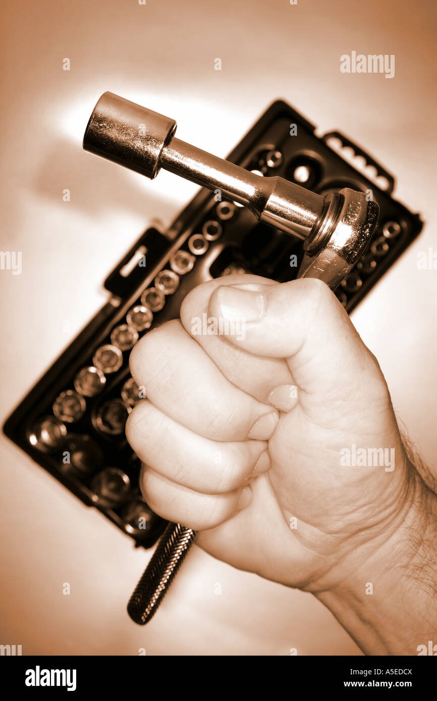 Hand holding ratchet Stock Photo - Alamy