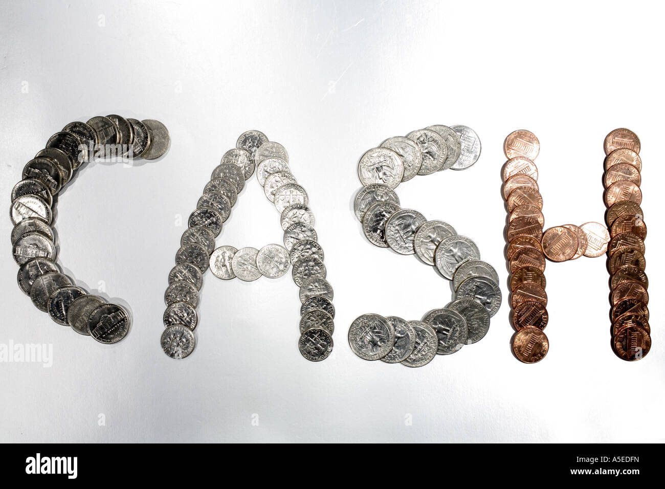 Coins spelling CASH Stock Photo - Alamy