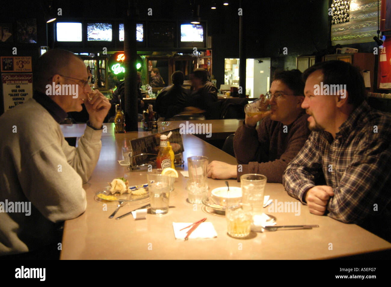 3 men having lunch Stock Photo - Alamy