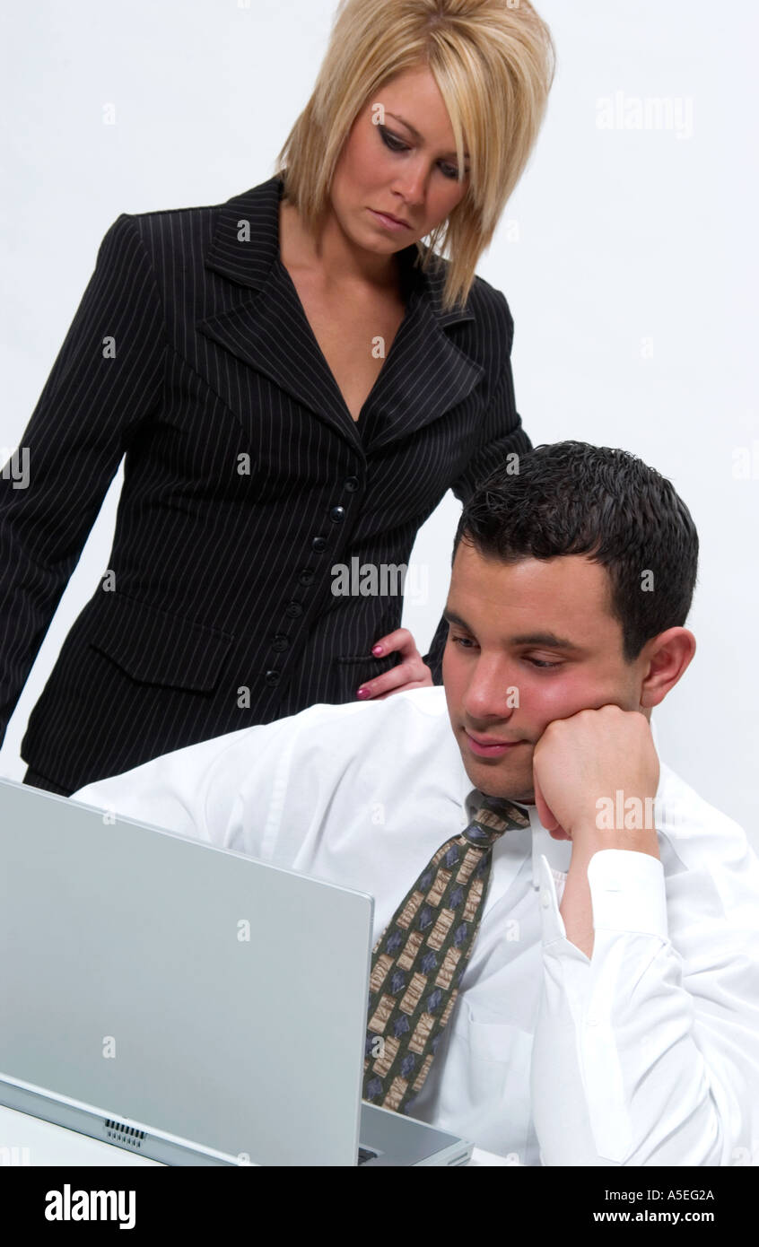 Man and woman working on laptop computer Stock Photo - Alamy
