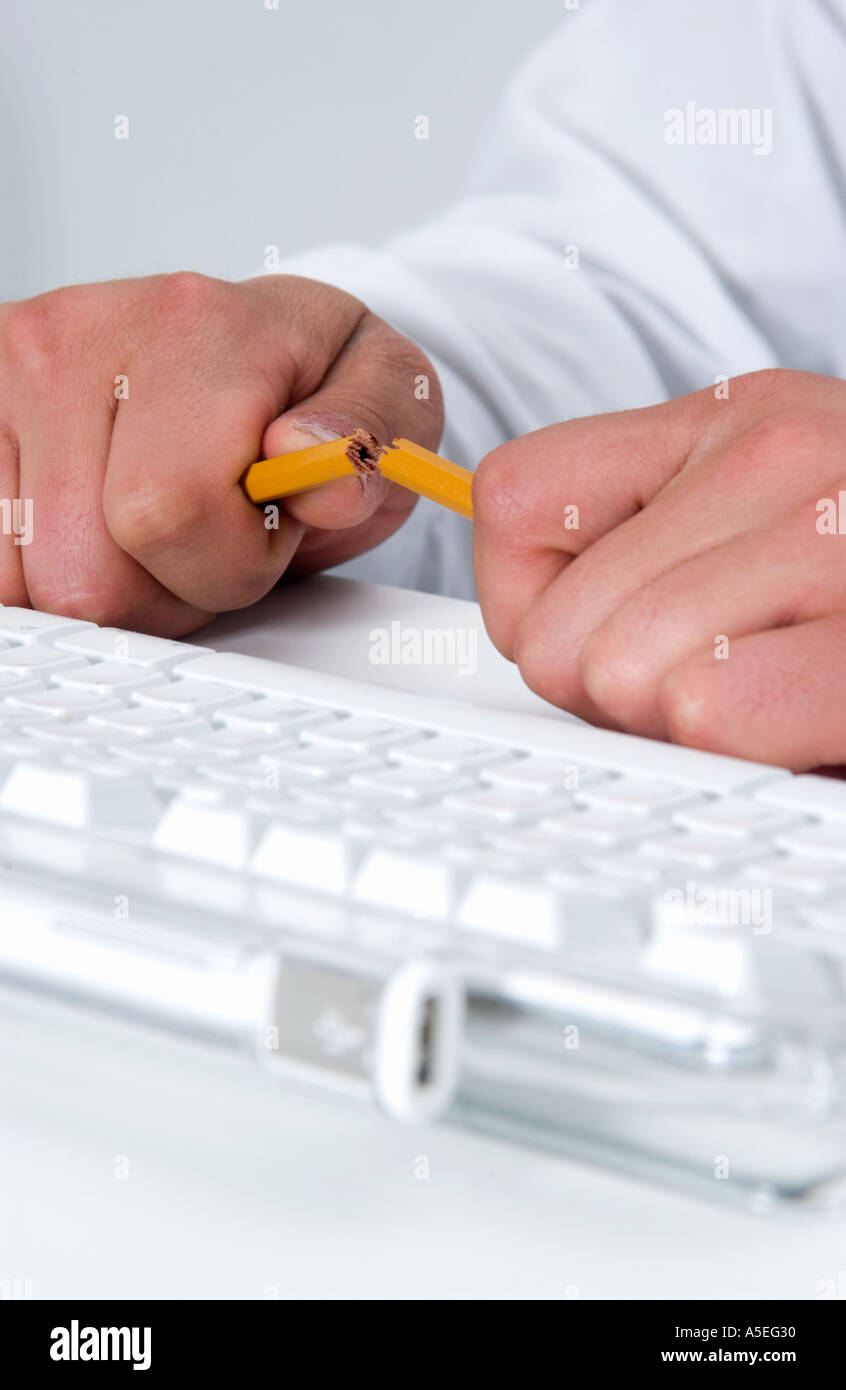 Man at computer breaking a pencil Stock Photo - Alamy