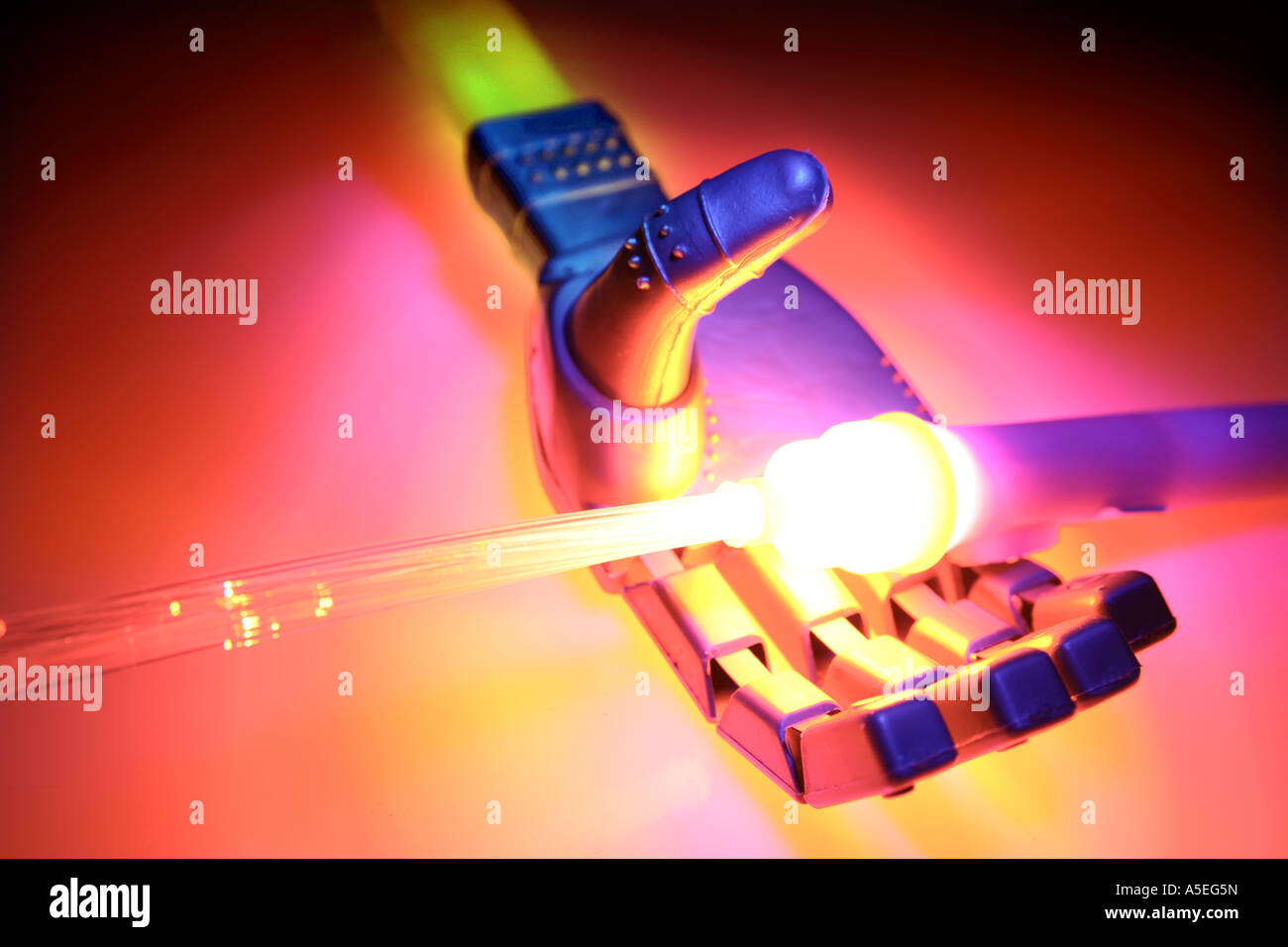 Robot hand holding light Stock Photo - Alamy