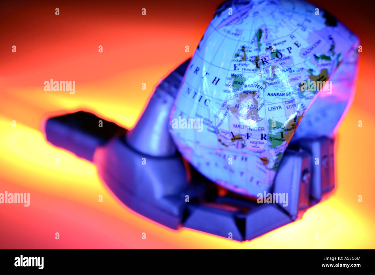 Robot hand crushing planet Stock Photo - Alamy