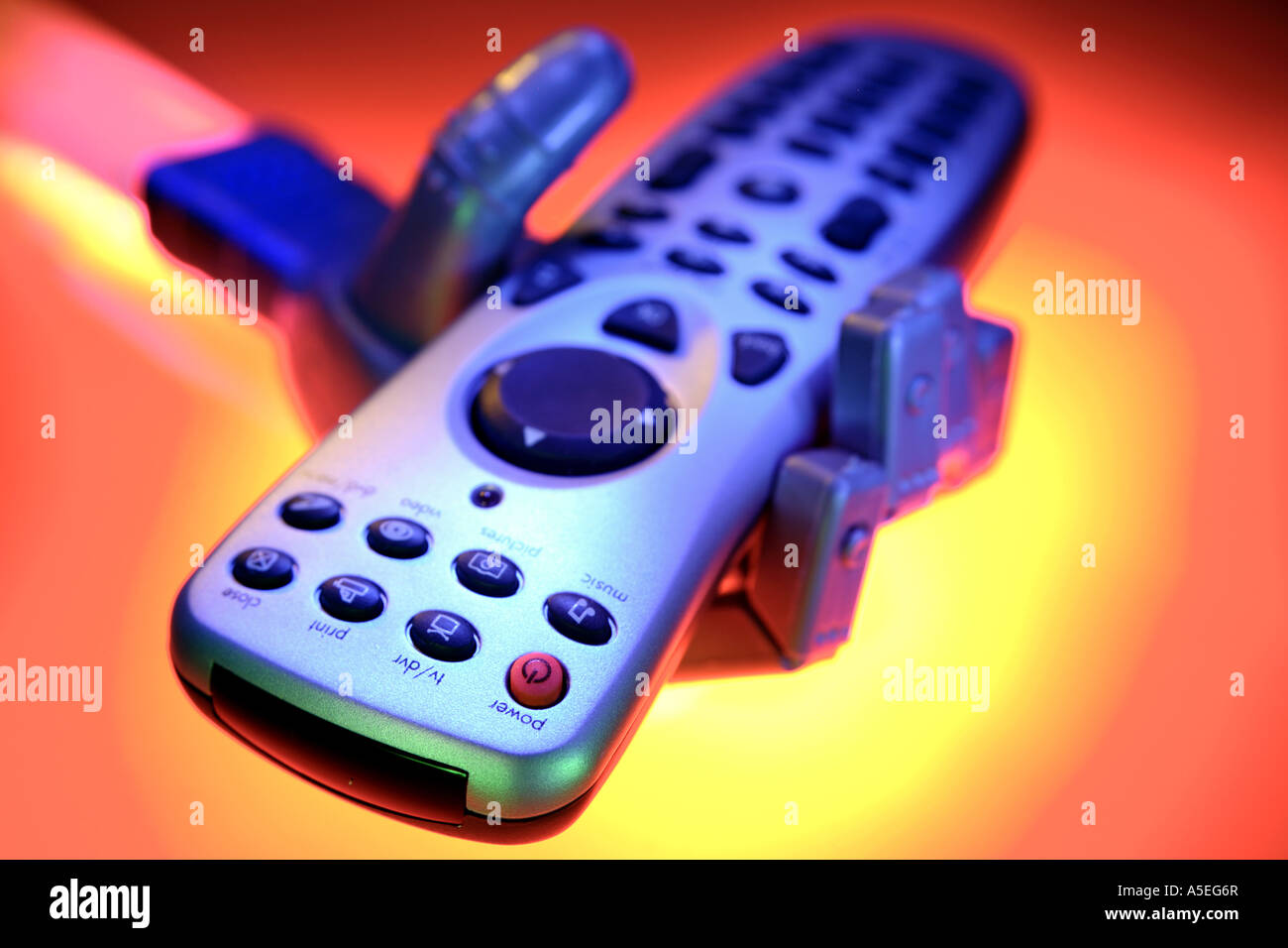 Robot hand holding remote control Stock Photo - Alamy