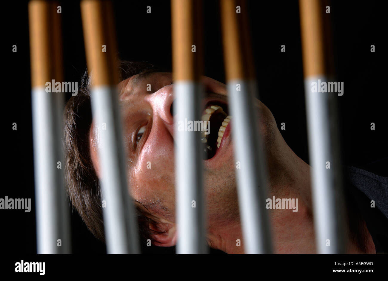 Trapped behind bars addiction cigarettes hi-res stock photography and ...