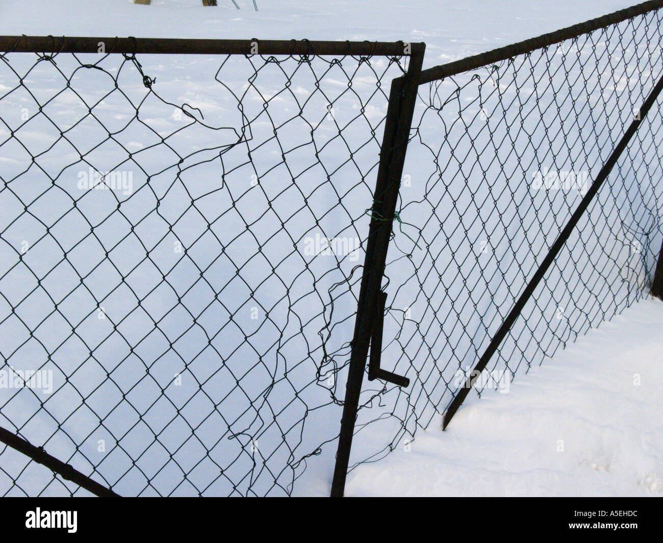 old, bended fence in the snow Stock Photo - Alamy