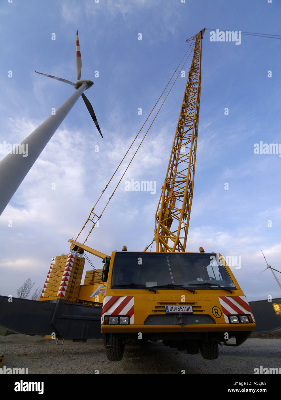 wind wheel with crane at a construction site with a freight vehicle ...