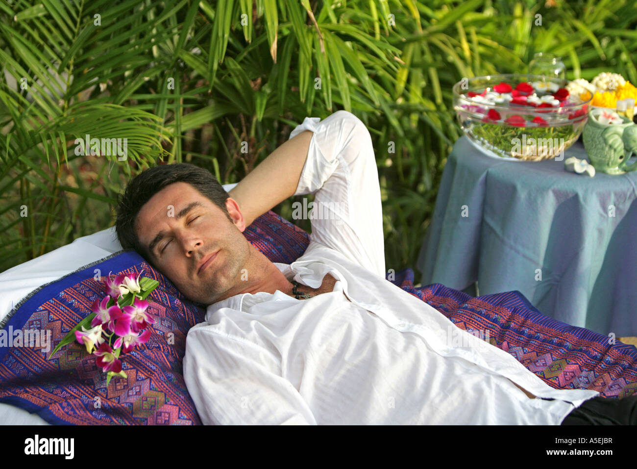 Man enjoying holidays at tropical garden in Thailand Stock Photo - Alamy