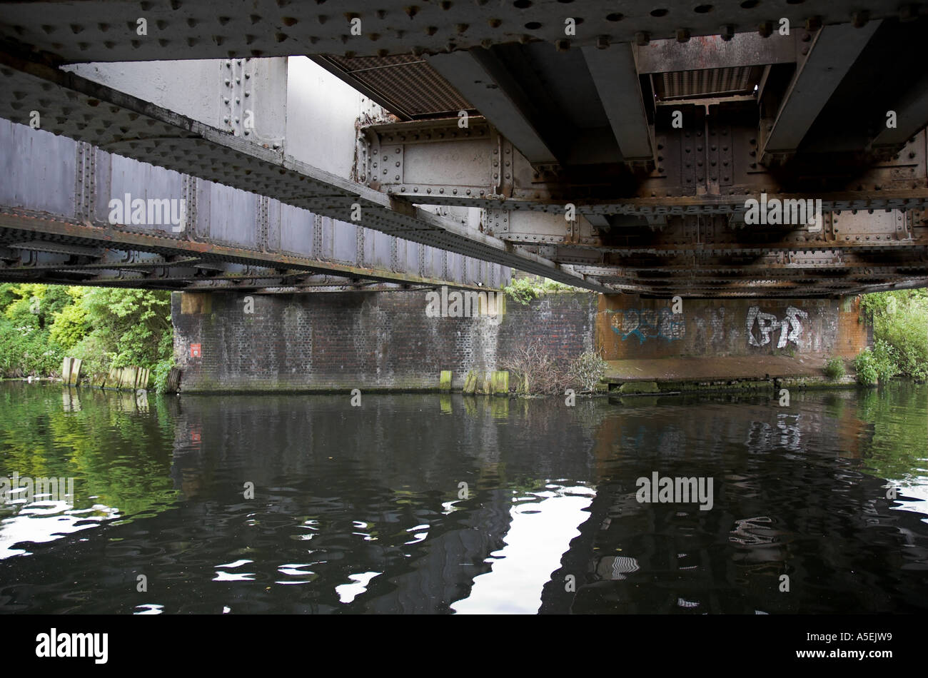 Underneath a railway bridge crossing the River Lea or Lee London UK ...