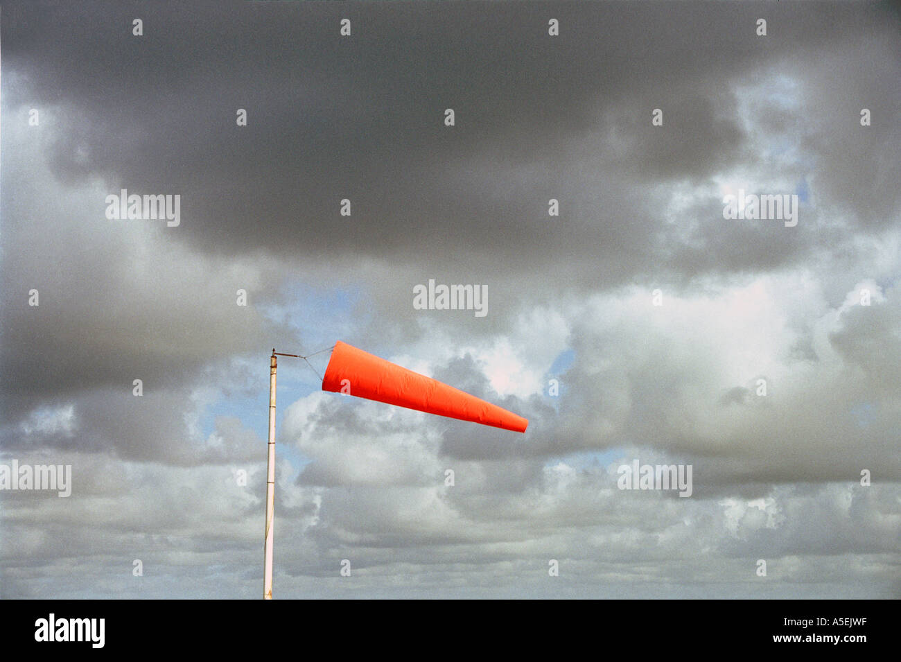 red windsock in windy sky Stock Photo - Alamy