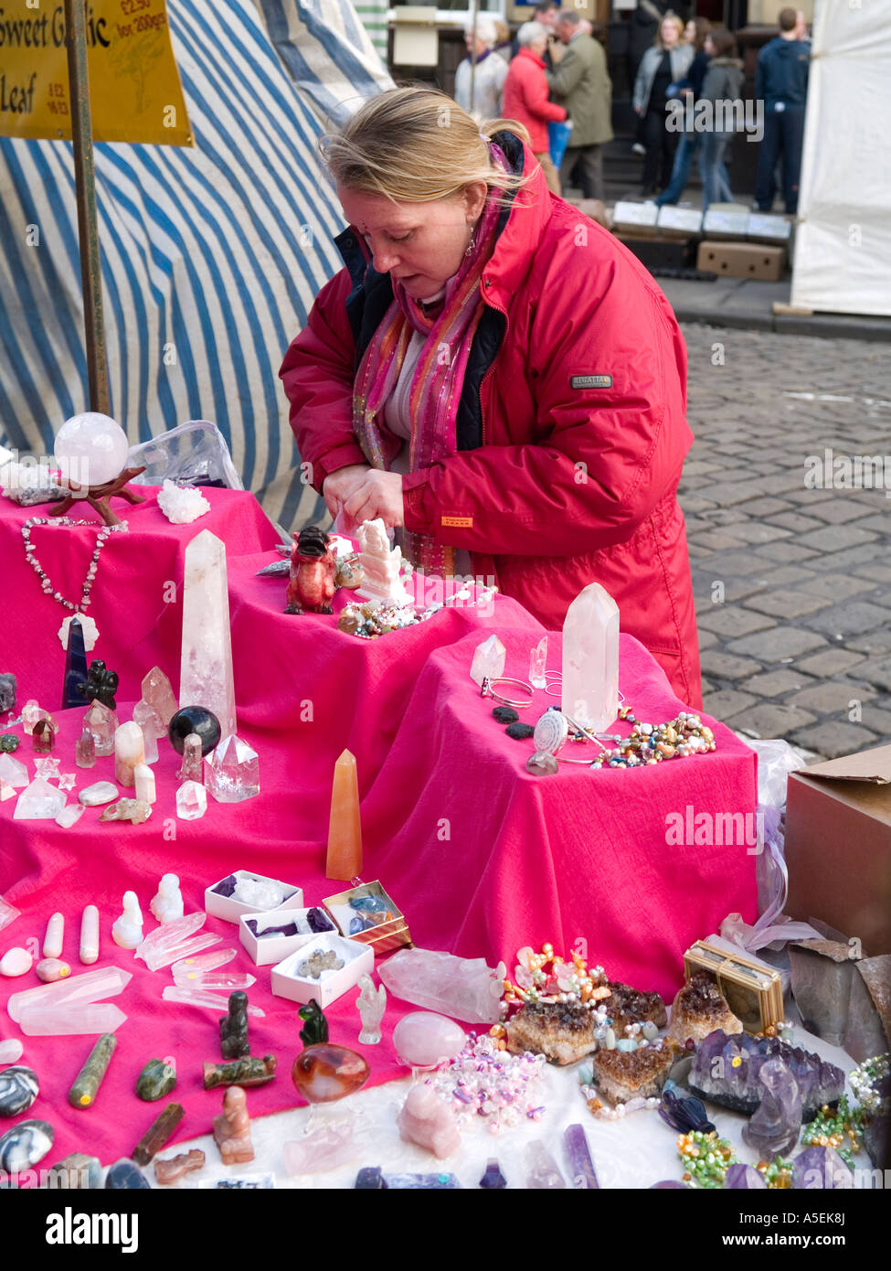 Stall holder selling rock crystals and jewellery from a market stall in ...
