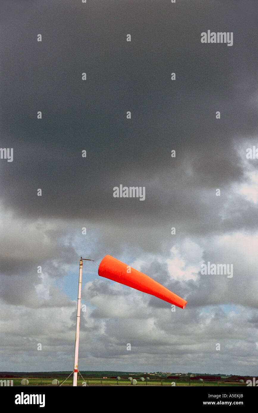one red wind sock and dramatic sky Stock Photo - Alamy