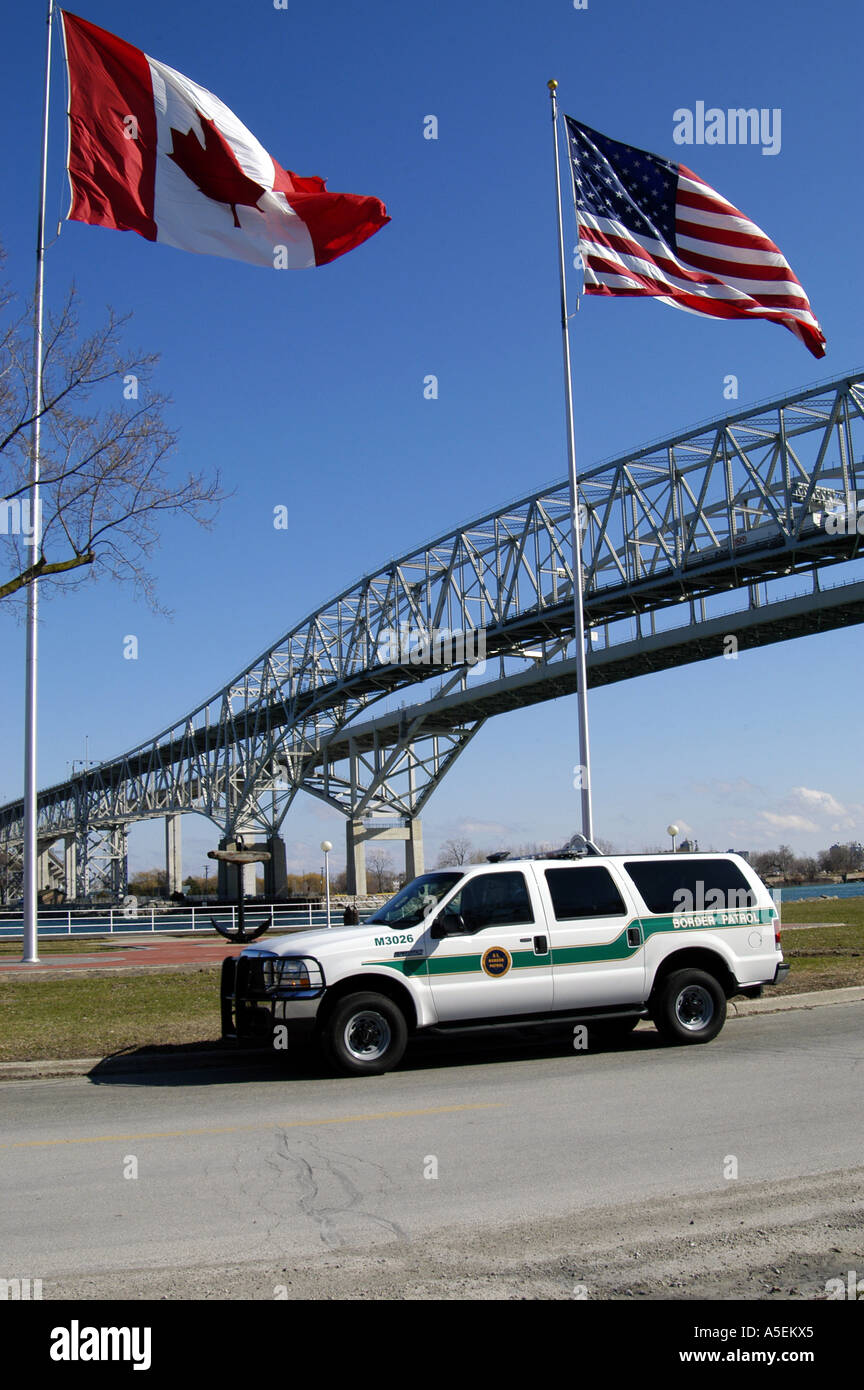 USA, Candadian flags flying over US Border Patrol SUV, Blue Water ...