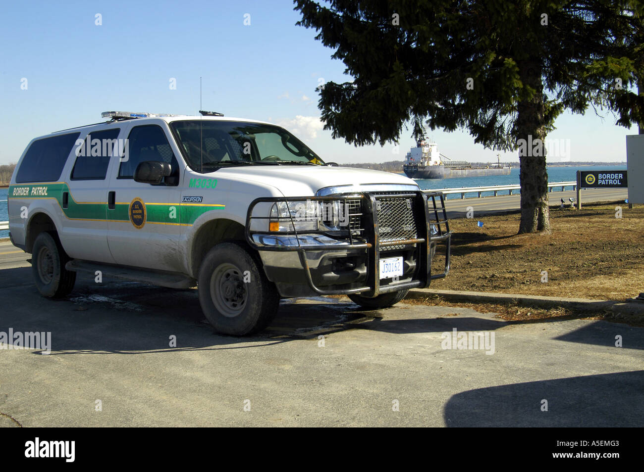 US Border Patrol SUV sitting near shore of St. Clair River, Ocean going ...